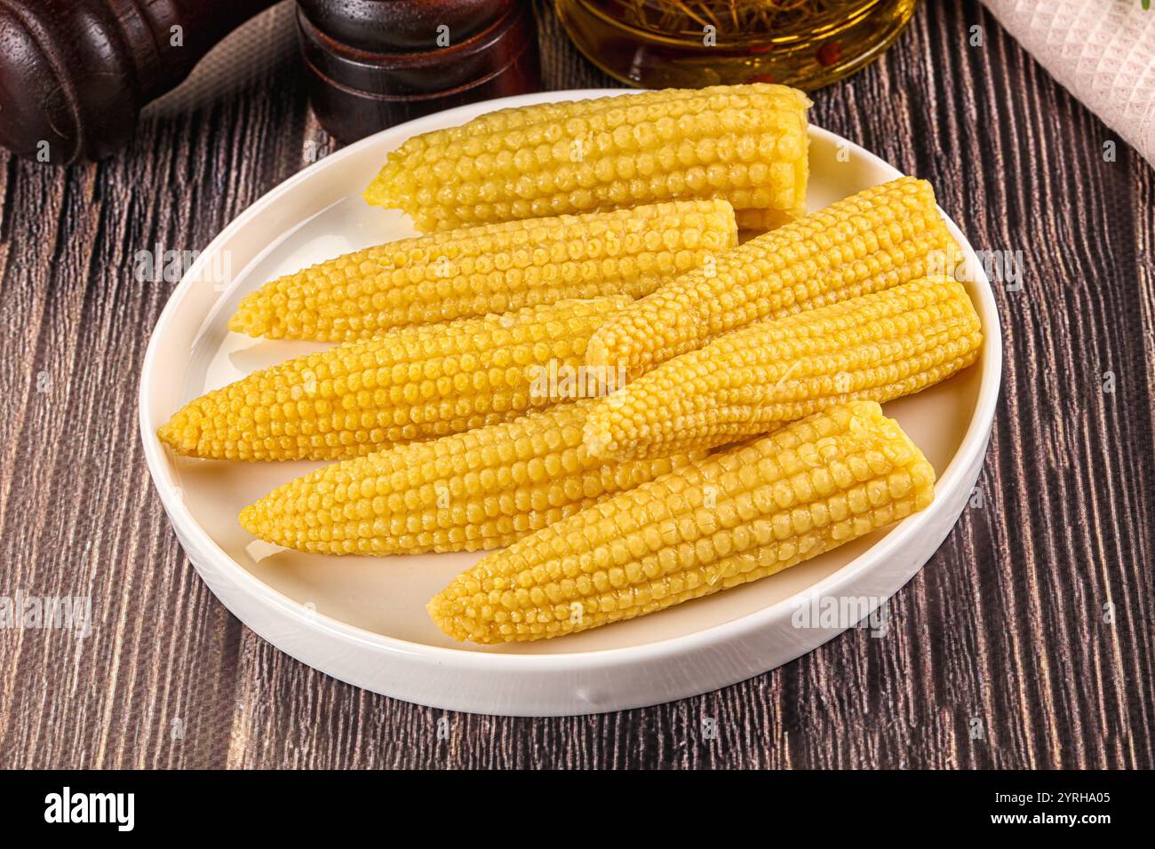 Canned baby mini corn cob in the plate Stock Photo - Alamy