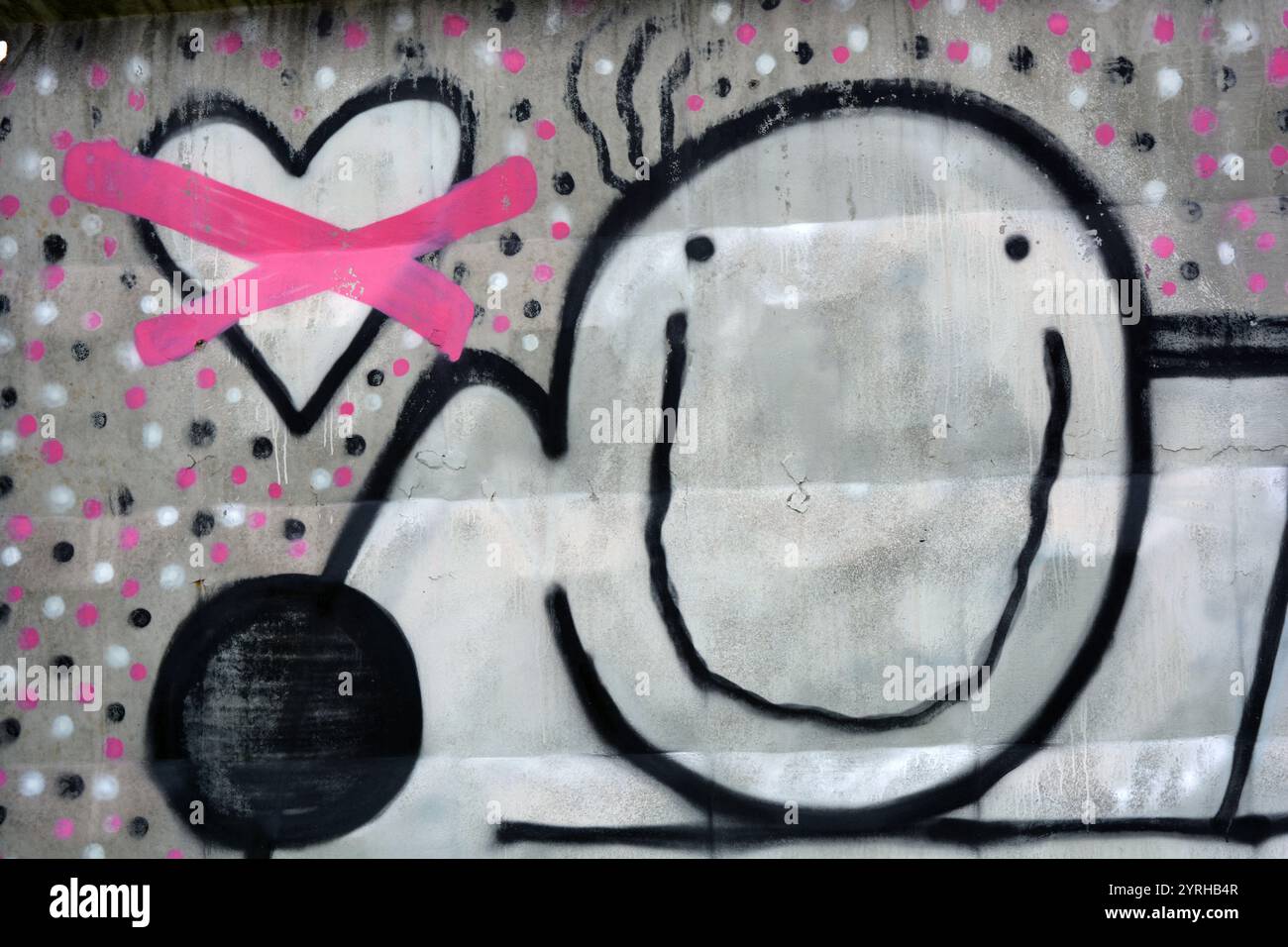 Graffiti, drawn with a white, black, pink spray drawing of a man in the ...