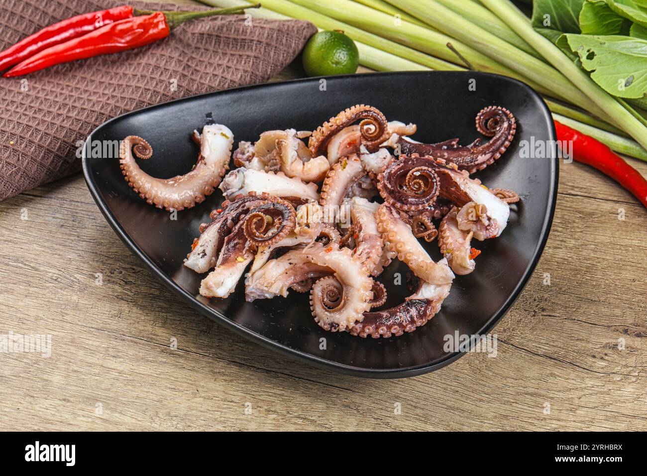 Grilled octopus red tentacle sliced appetizer Stock Photo - Alamy