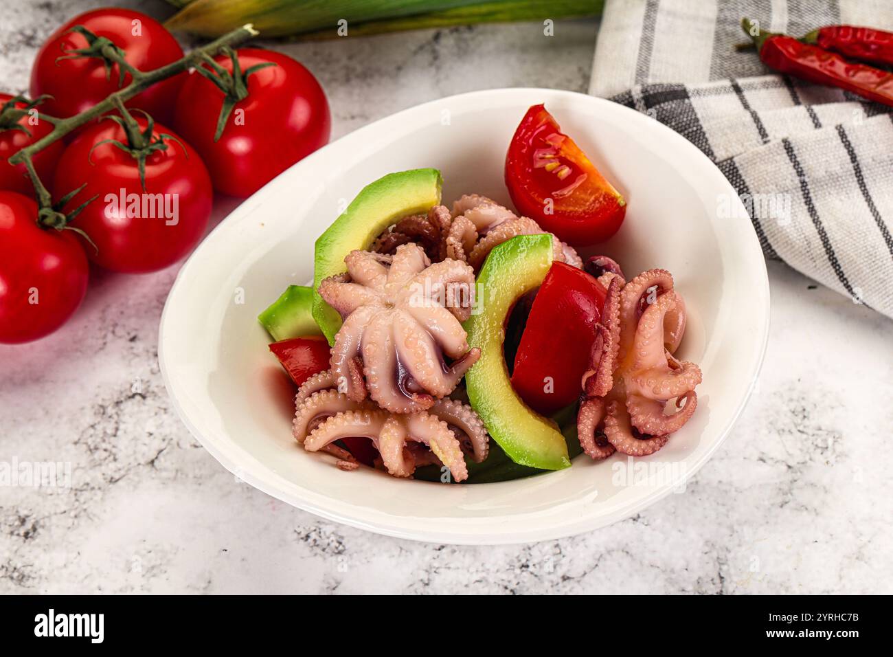 Salad with baby octopus, tomato and avocado Stock Photo - Alamy