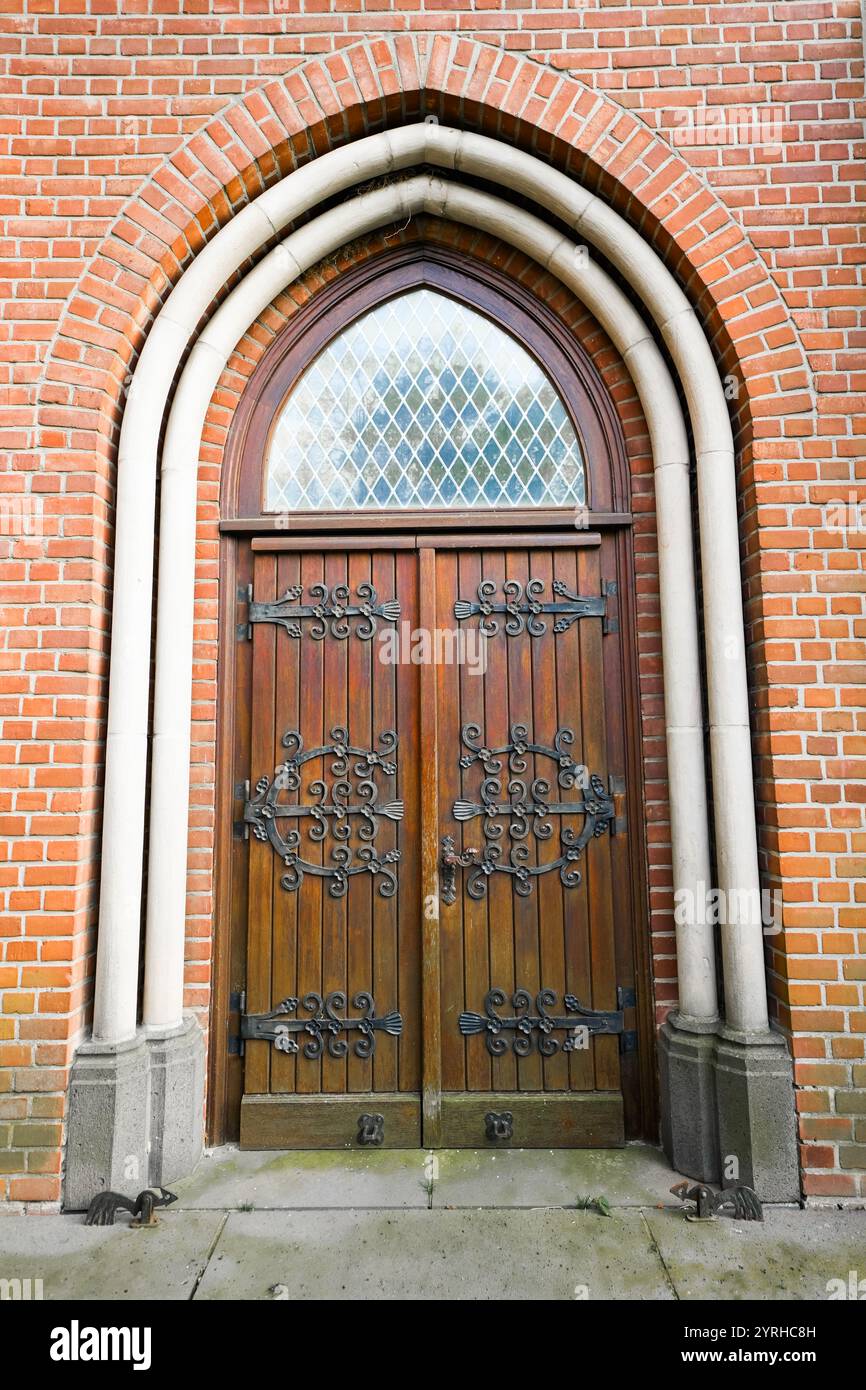 Old door of a European church with a round arch. Antique entrance made ...