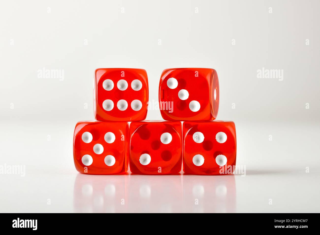 Set stack of transparent red gambling dice reflected on white table and ...