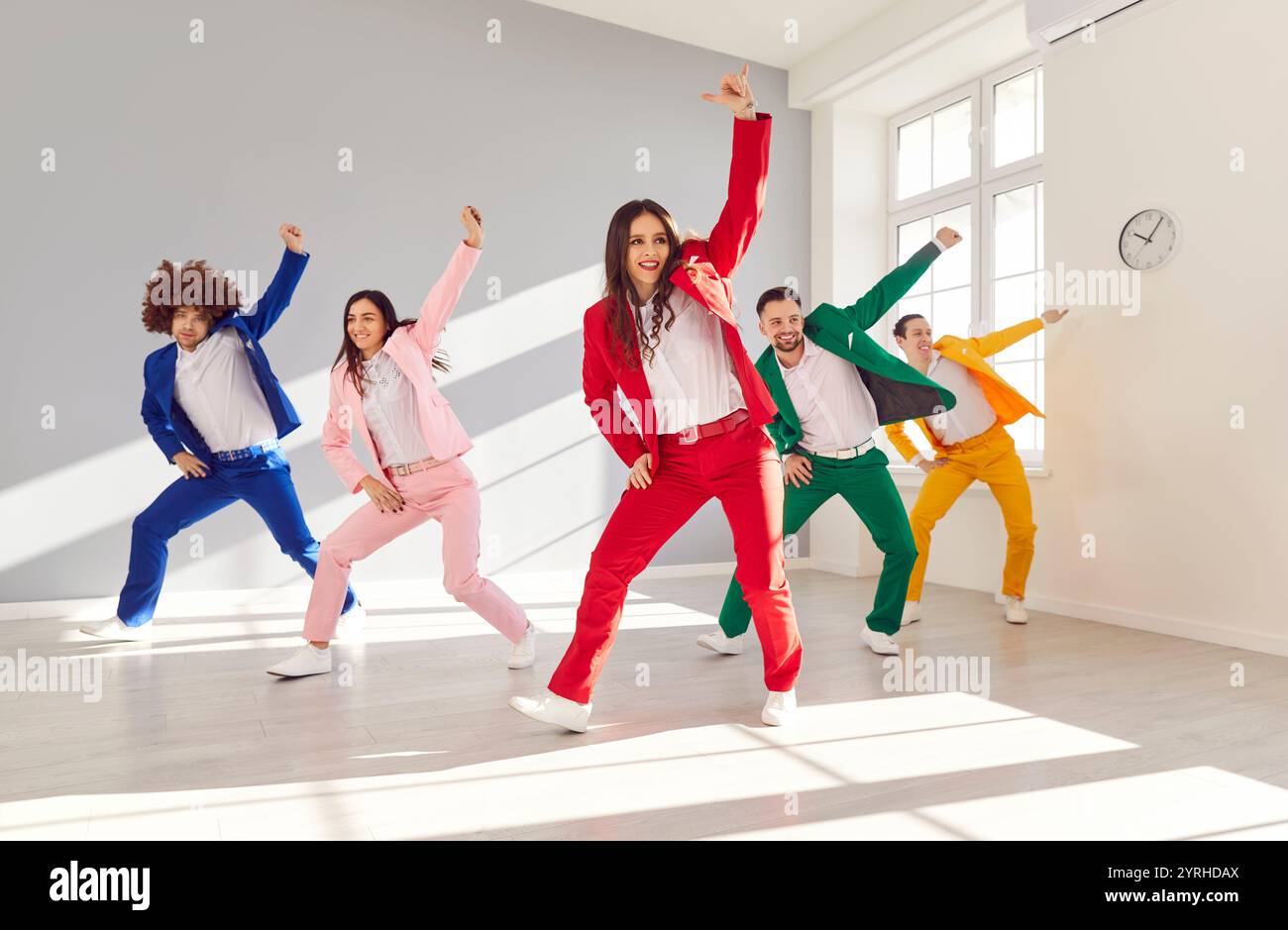 Happy Group Dancing In Colorful Business Suits Stock Photo - Alamy