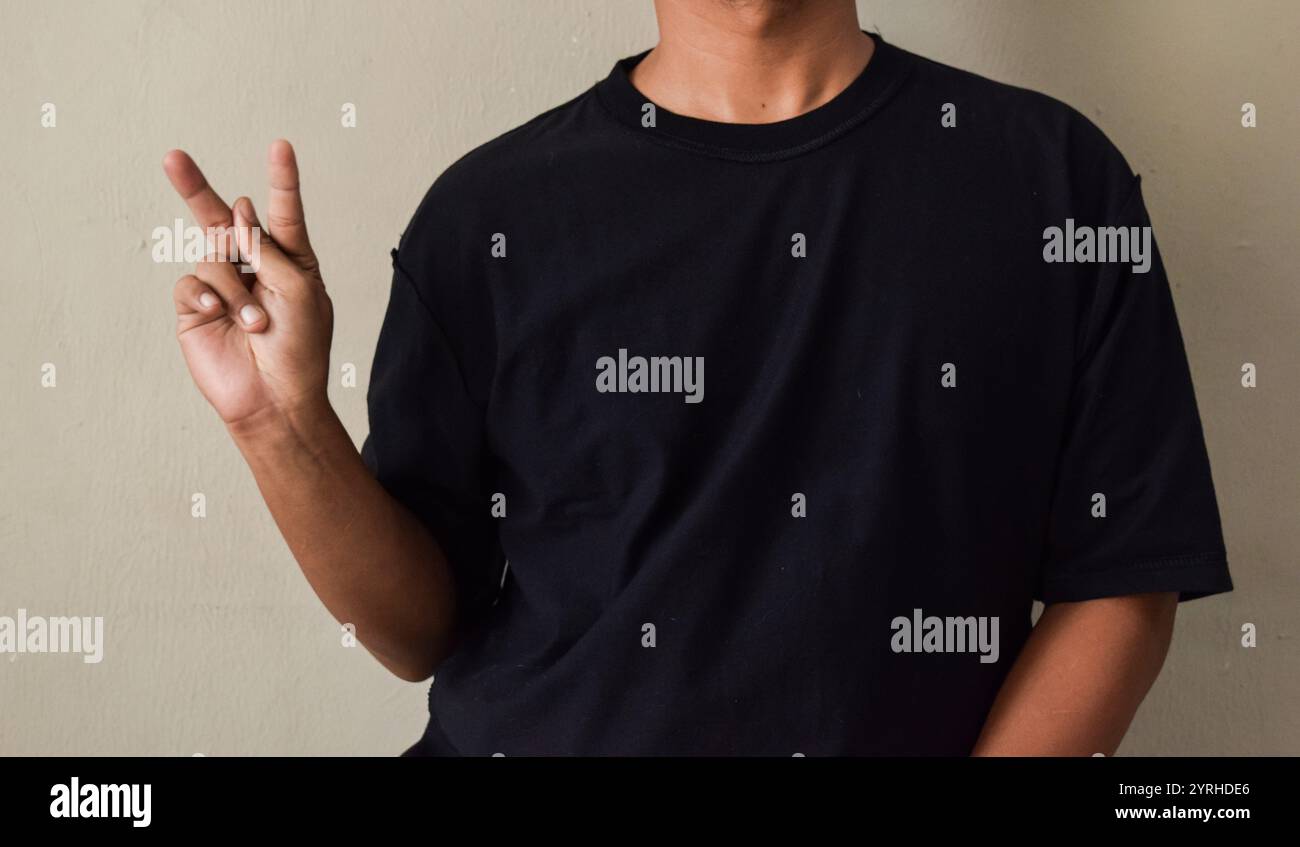 Young man letter K. Finger spelling alphabet in ASL Stock Photo - Alamy