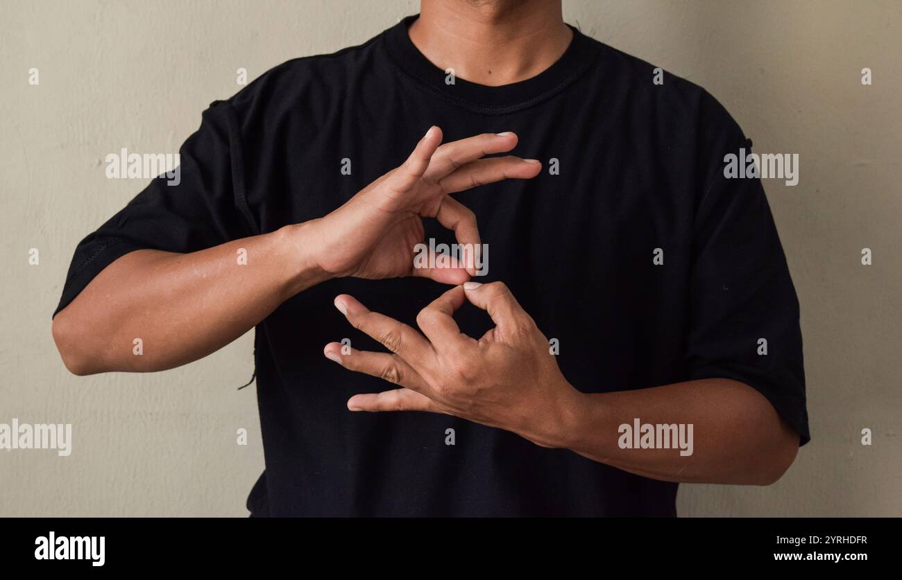 Young man learns sign language to talk, hand gestures of people with ...