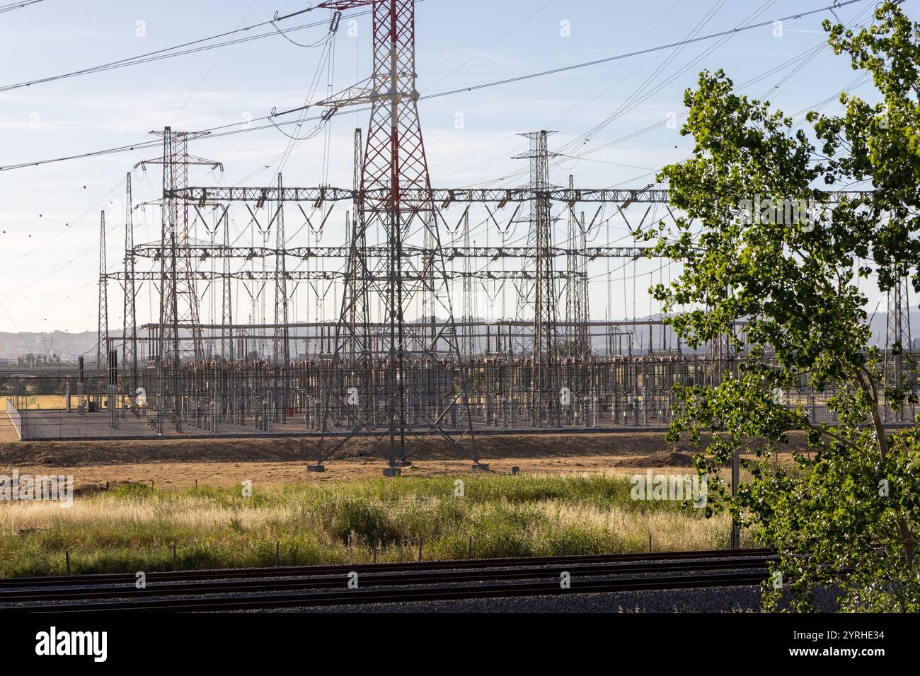 Electrical substation distributes high voltage electricity through a ...