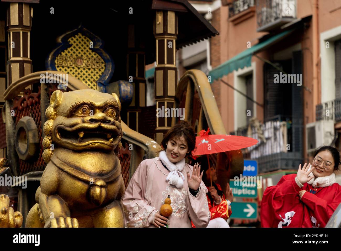 Happy Chinese volunteers between Fu lions sculptures on a Lunar New ...