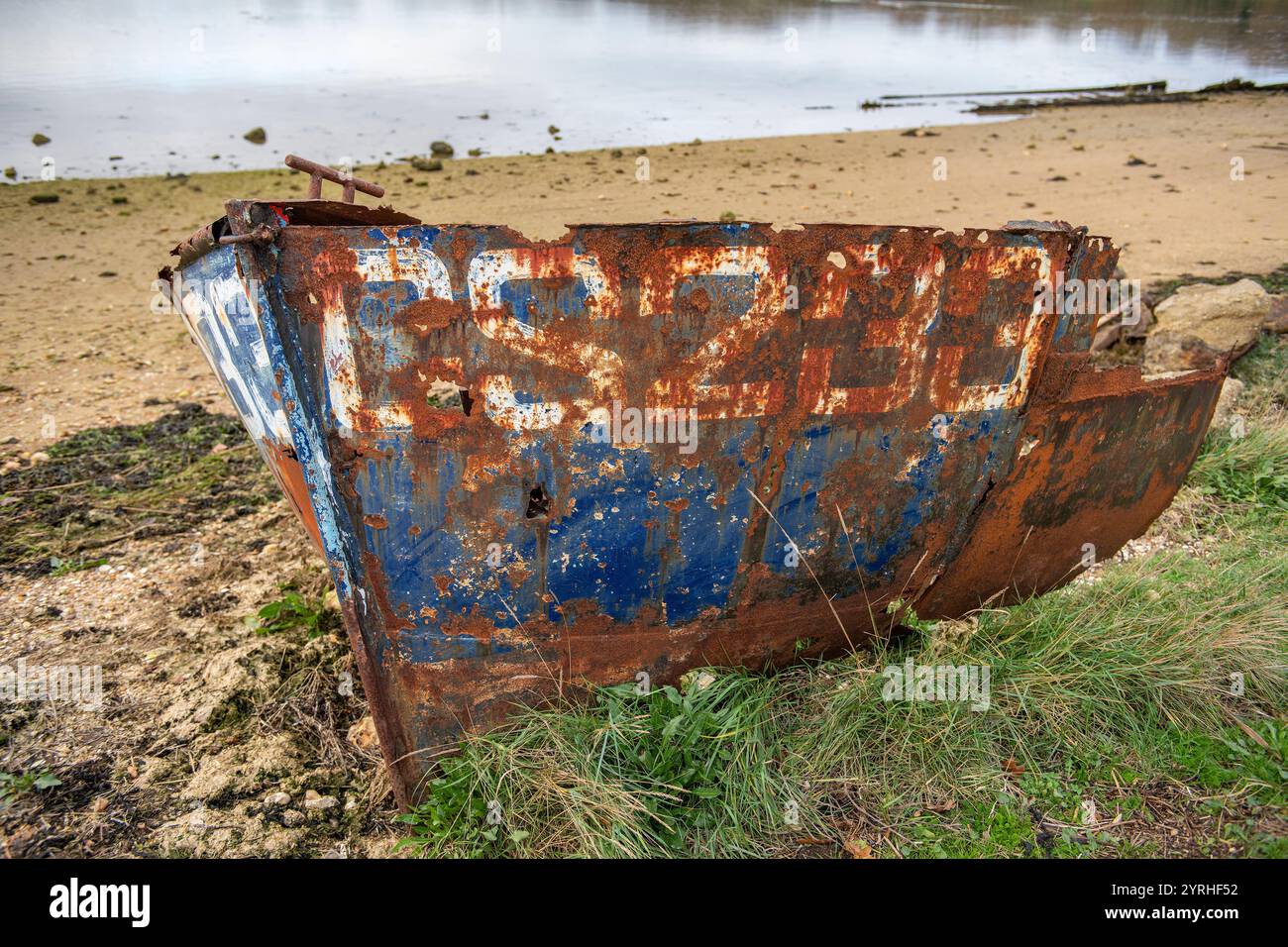 rusty old wreck of a fishing boat washed up at the strand line on a ...