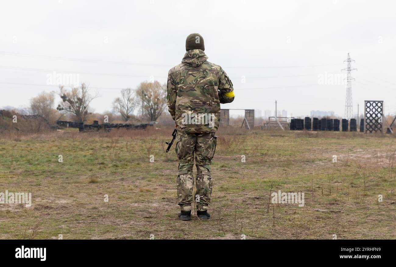 A young man in camouflage with a machine gun is seen before performing ...