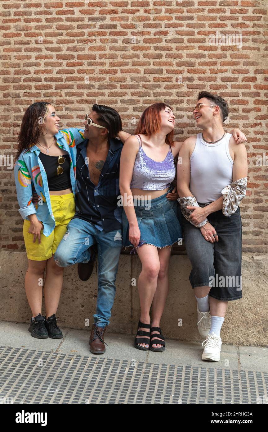 A lively group of four friends enjoying a cheerful moment as they laugh ...