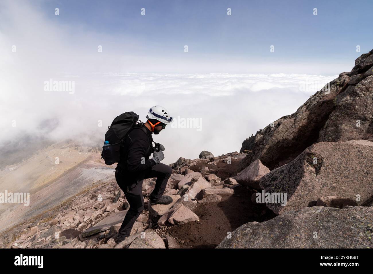 A climber in gear navigates the rocky path of La Malinche volcano in ...