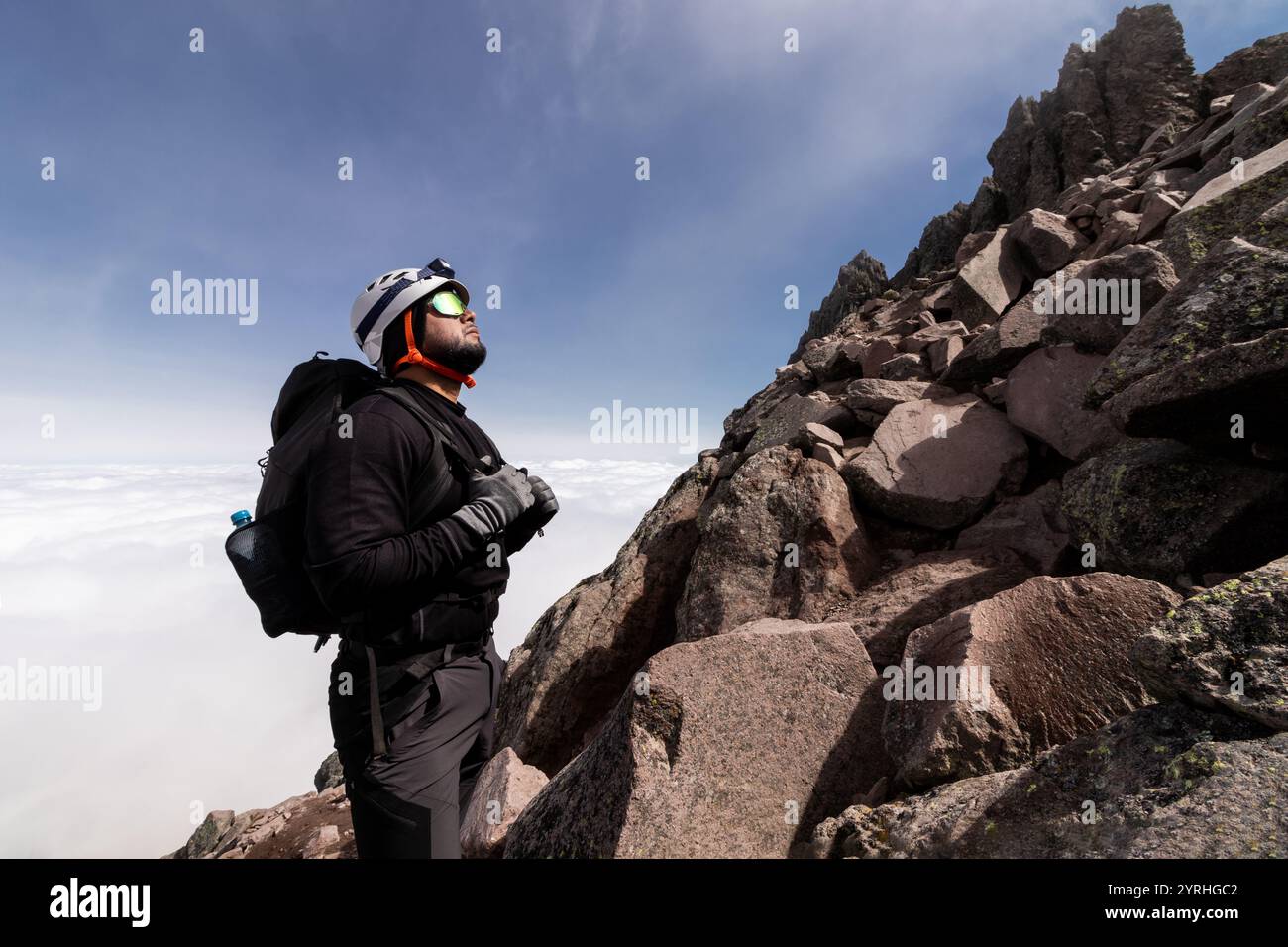 A climber, equipped with gear, ascends the rocky terrain of La Malinche ...