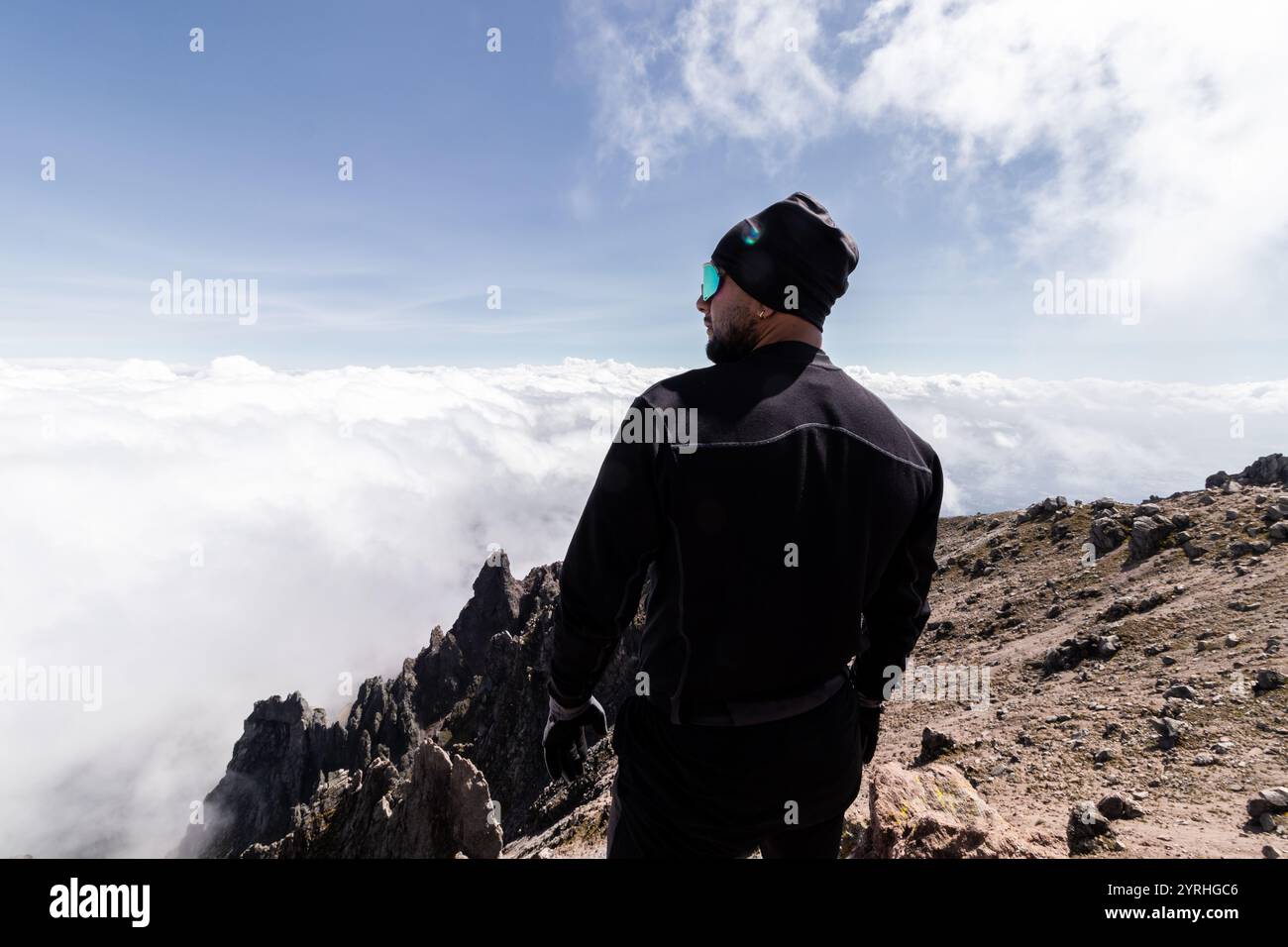 An adventurer stands atop La Malinche volcano in Mexico, gazing at a ...
