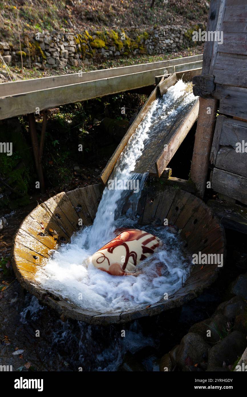 A traditional water-powered mill in Maramures, Romania, illustrates ...