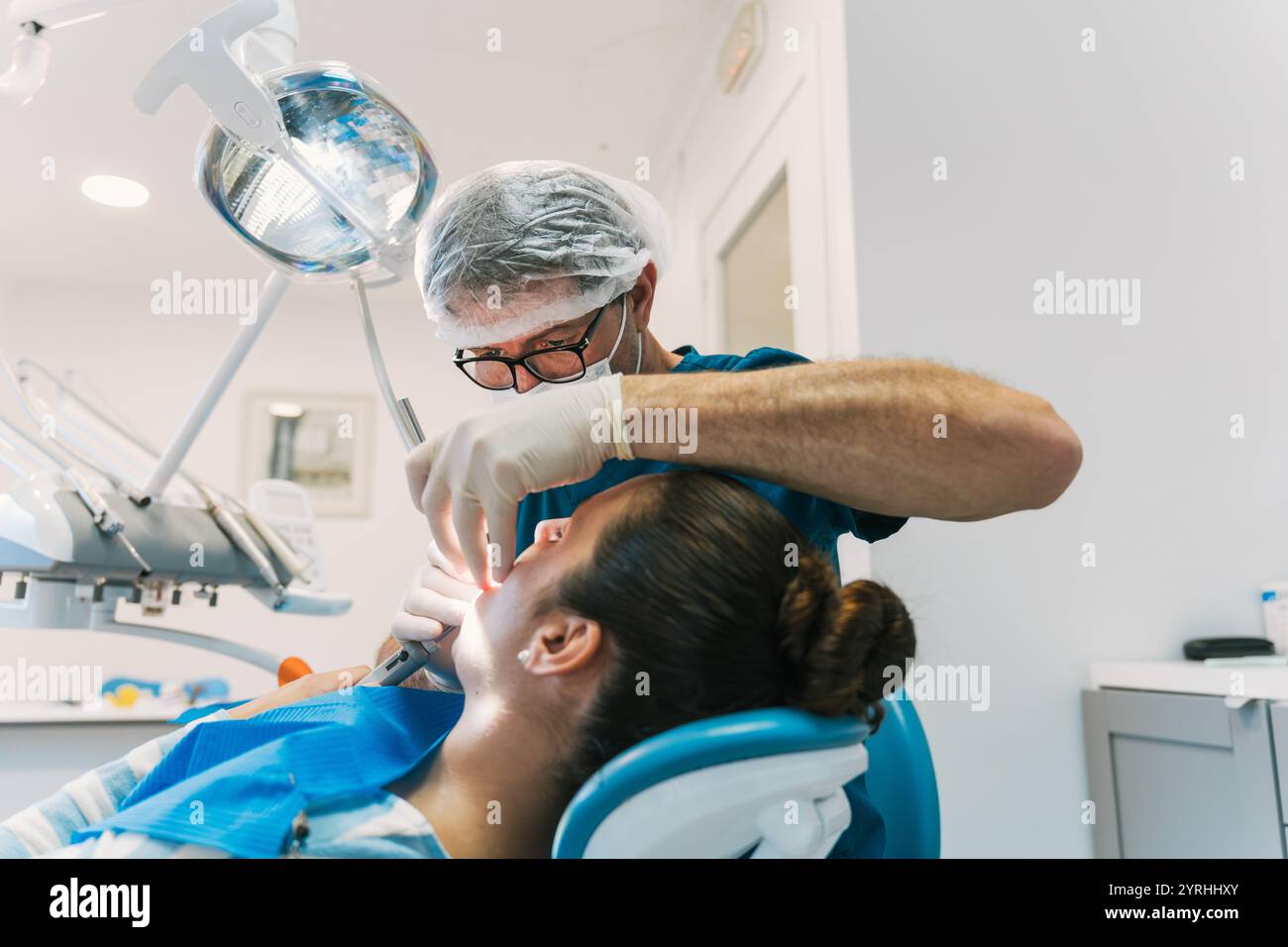 Dentist carefully examines hi-res stock photography and images - Alamy