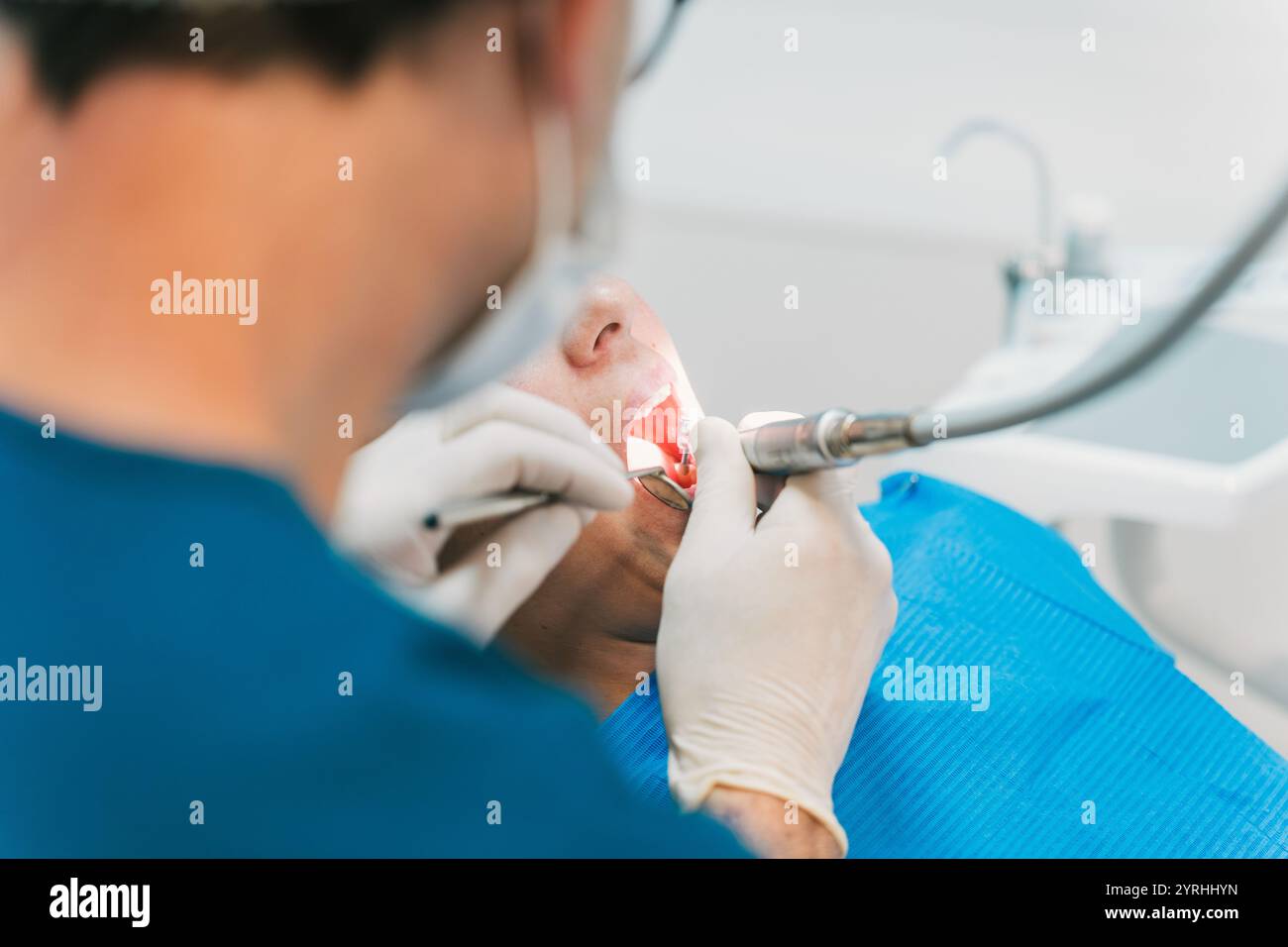 A dentist performs a dental check-up, using specialized tools on a ...