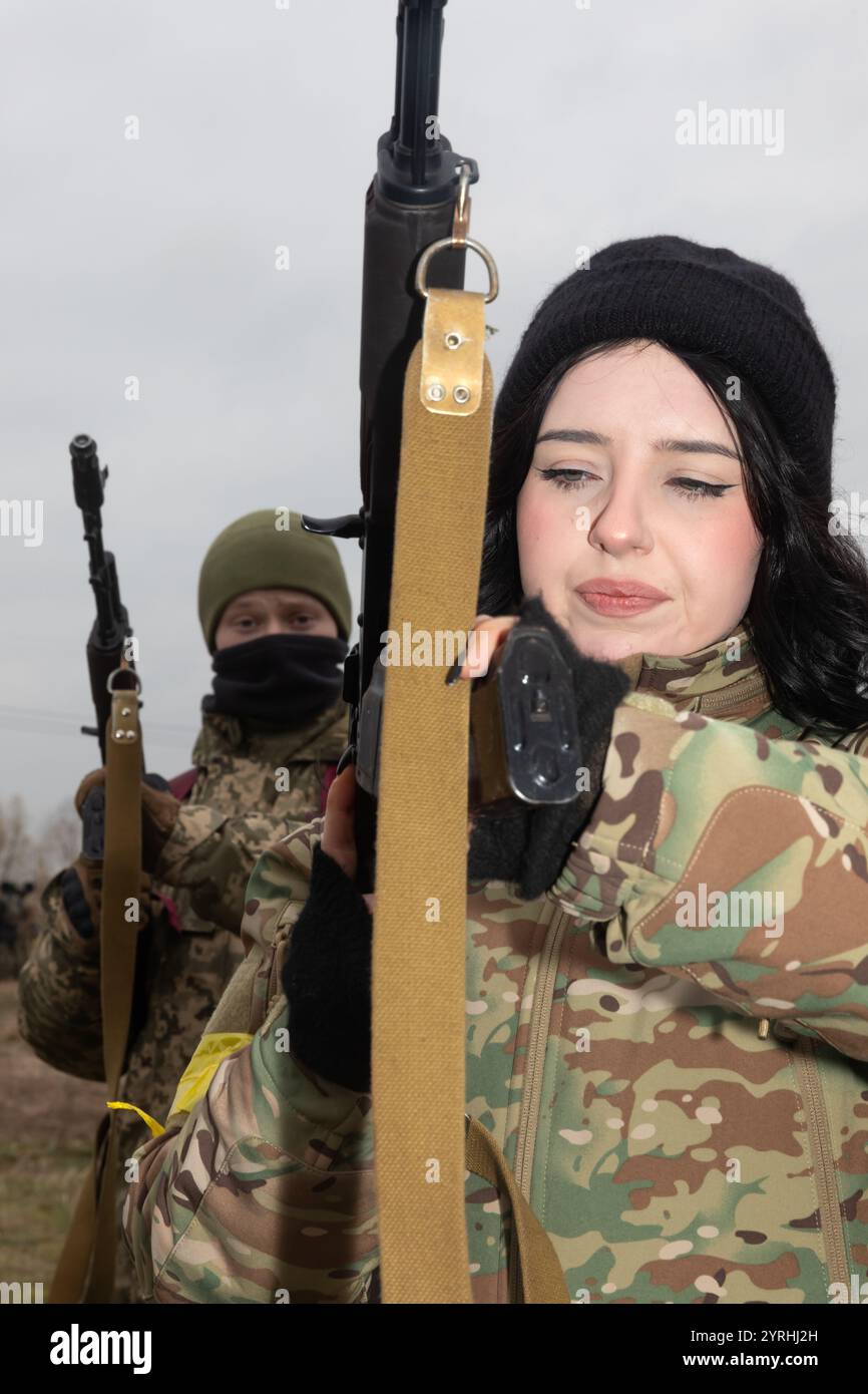 Two girls with automatic rifles are seen during a military exercise for ...