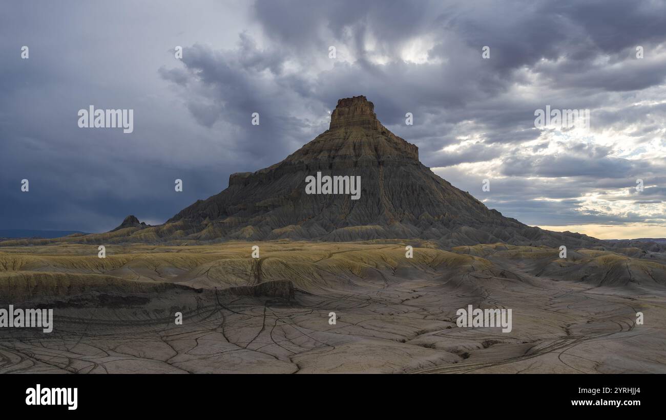 Captivating view of Factory Butte rising under moody, cloud-filled ...