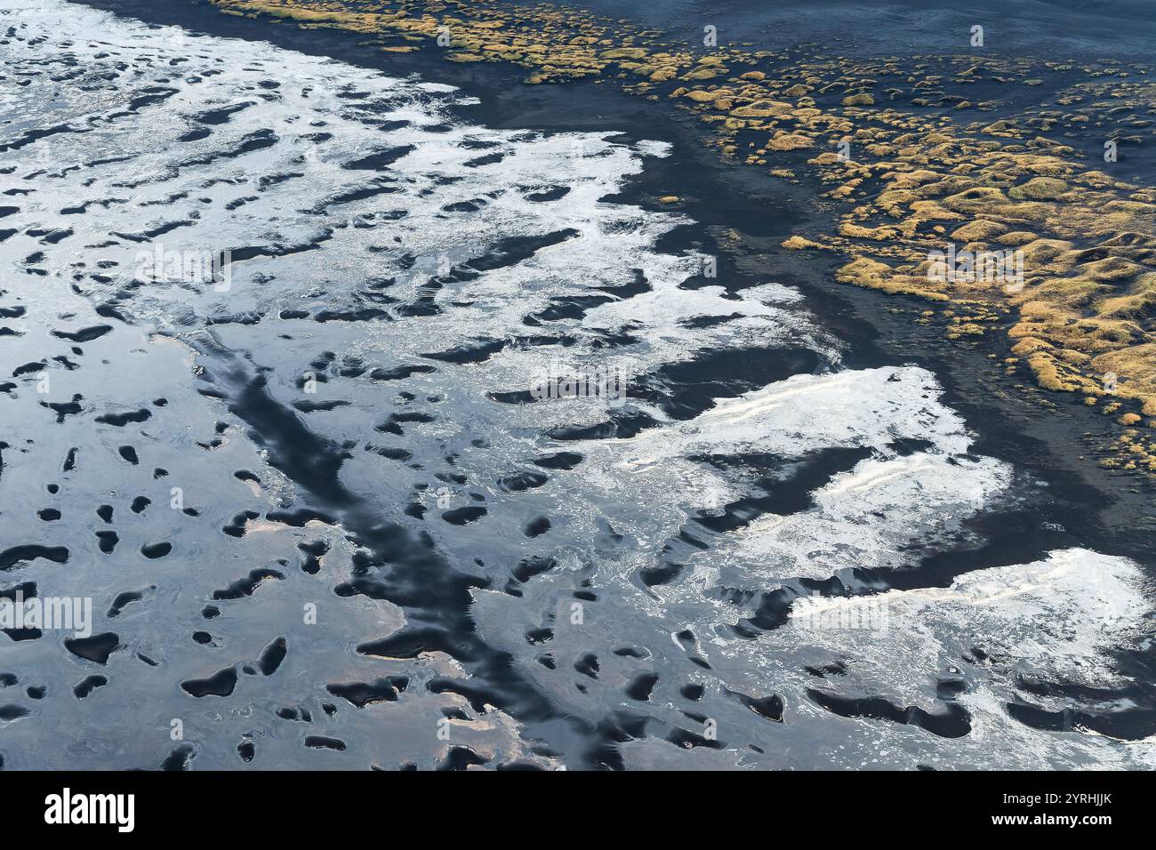 Aerial view of Iceland's south coast, showcasing contrasting textures ...