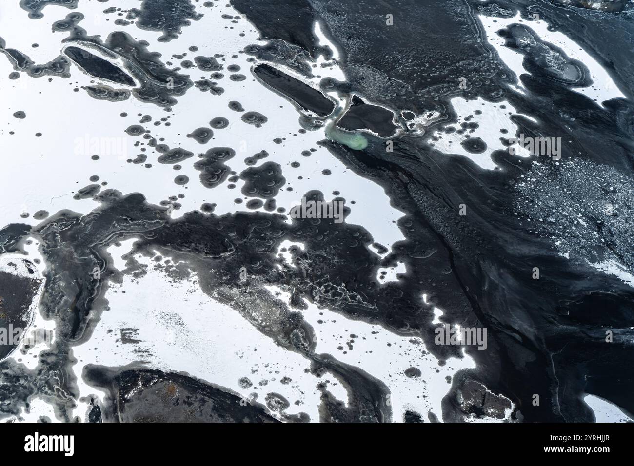 Aerial shot capturing the stunning natural patterns of ice and rock on ...