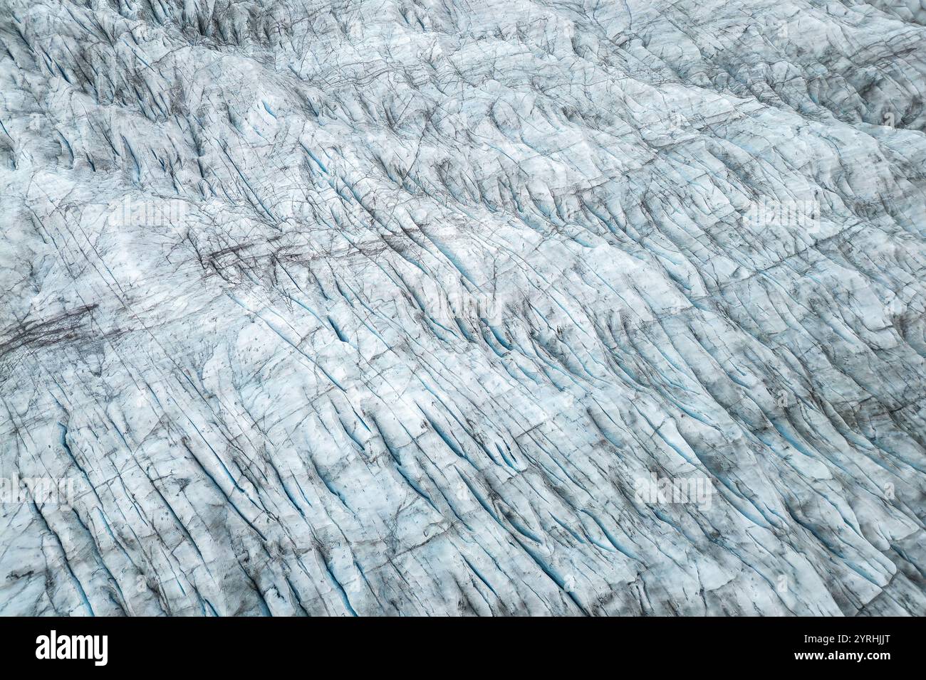 Aerial shot showing the intricate patterns and textures of a glacier ...