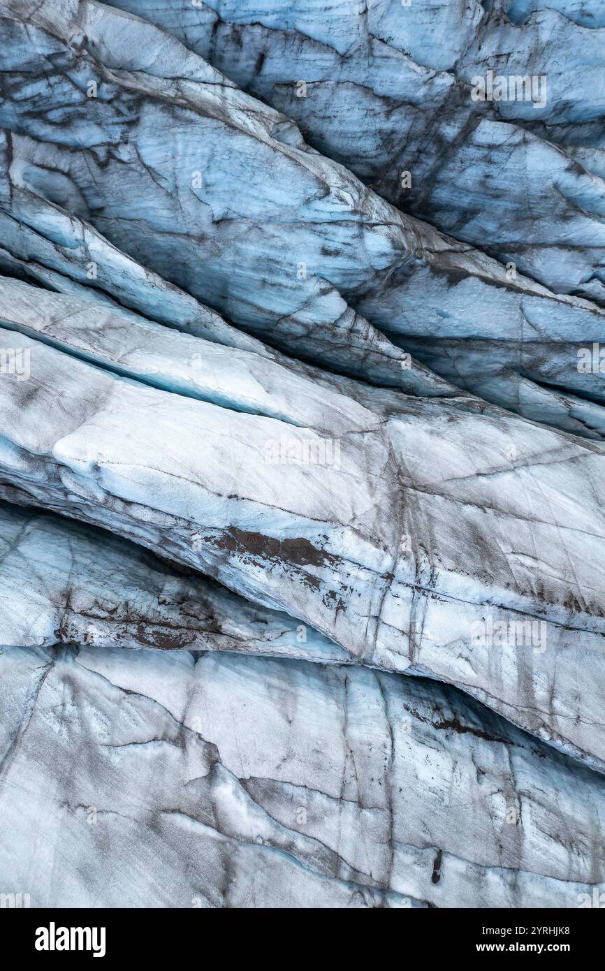A detailed view of glacial ice formations showcases intricate textures ...