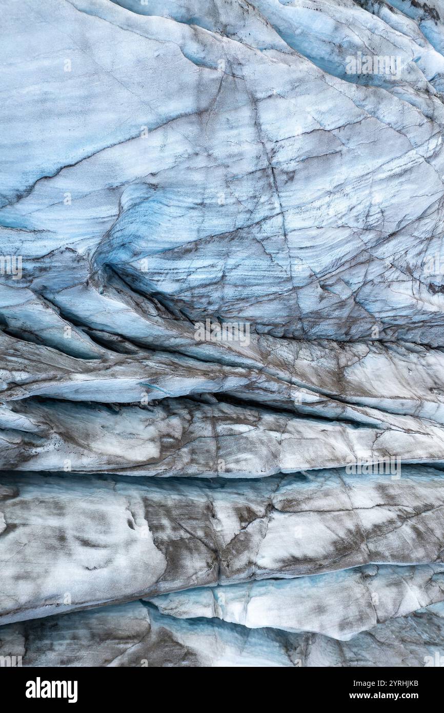 Intricate layers of ice and sediment form unique textures in a glacier ...