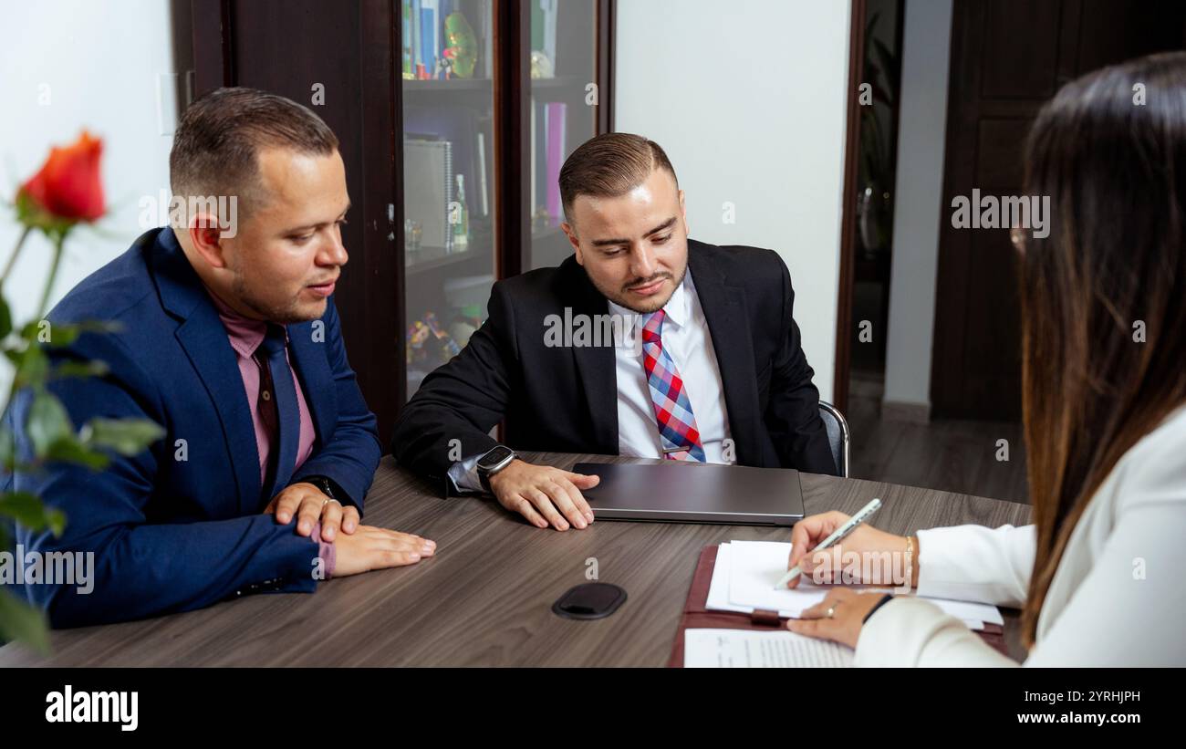 A professional meeting featuring two latino lawyers and a third person ...
