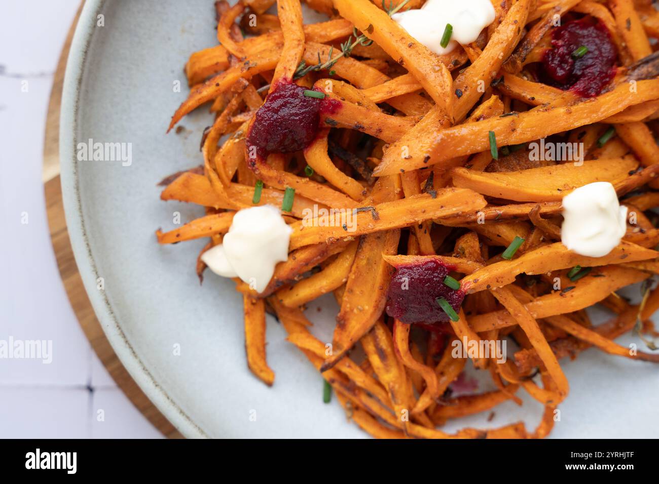 Crispy baked sweet potato sticks, seasoned with aromatic spices, served ...