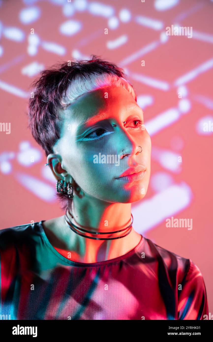Futuristic woman with a punk hairstyle and body piercings, bathed in ...