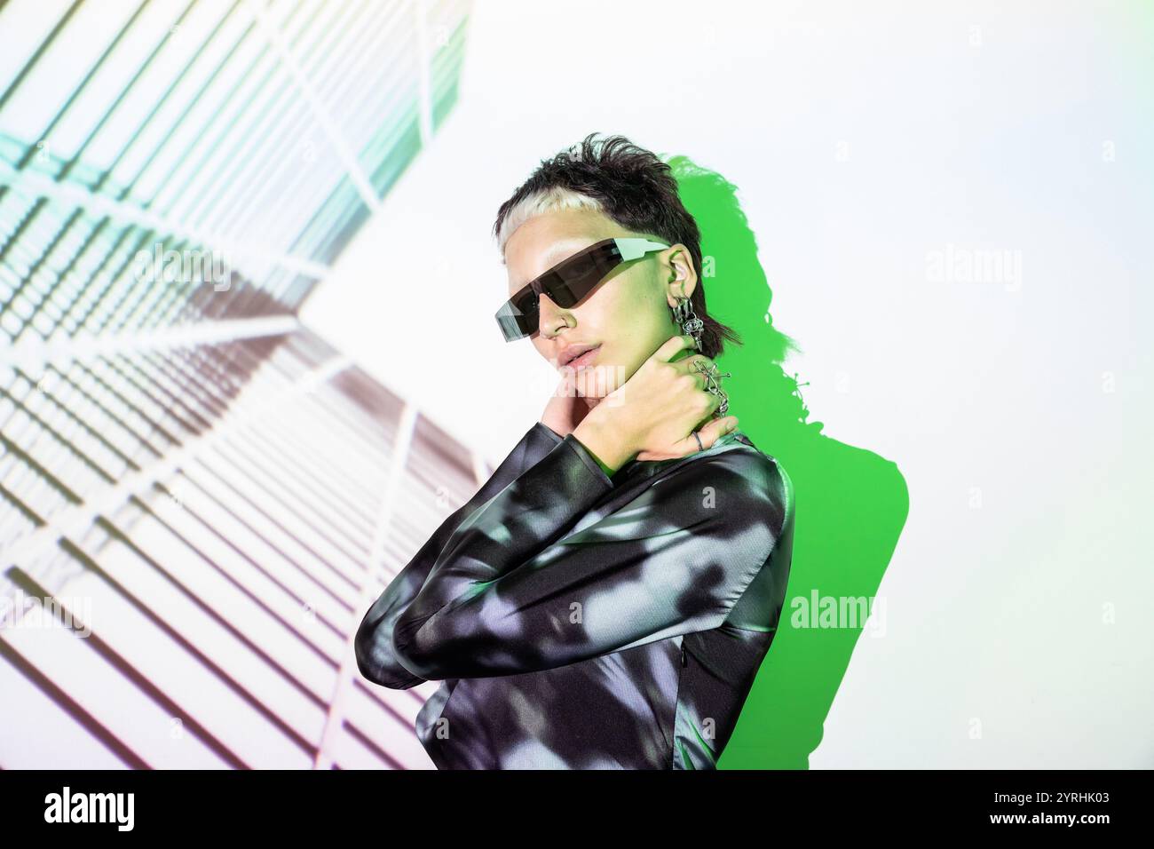 A trendy, futuristic woman poses in a starkly modern setting, featuring ...