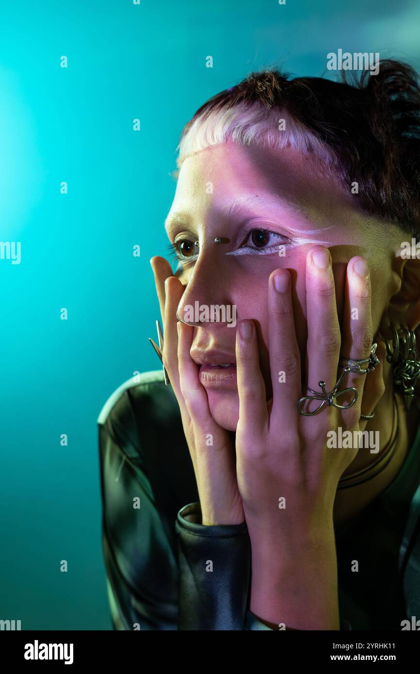 A close-up portrait of a futuristic woman gazing intently while holding ...