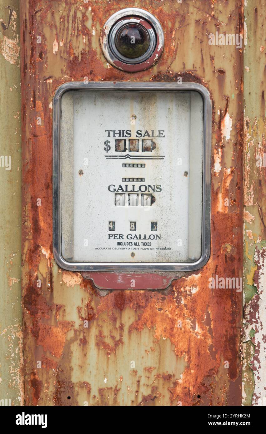 Close-up of a vintage gas pump with faded, rusty, and peeling paint ...