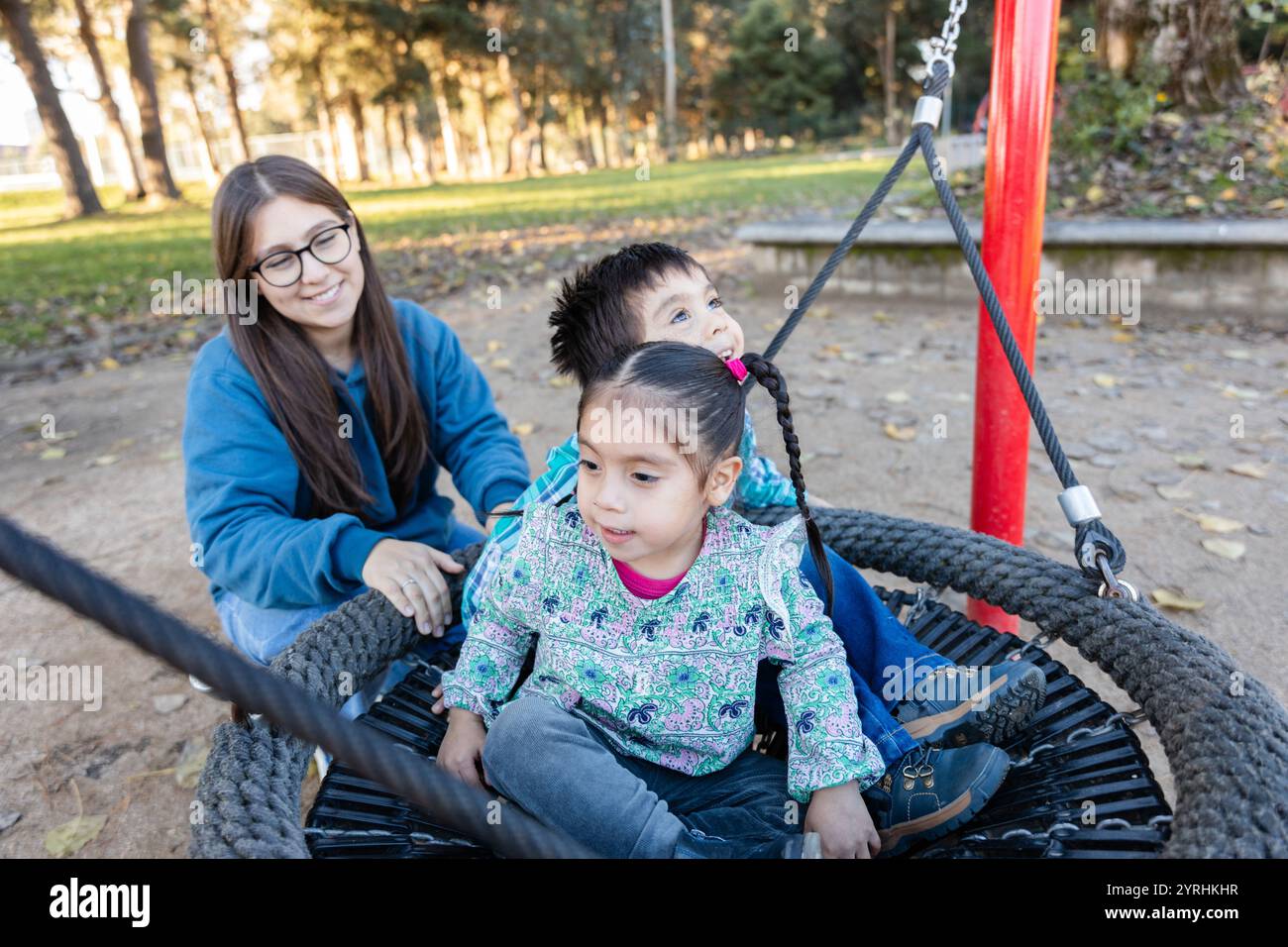 A family spends quality time at a park The older sister smiles as she ...