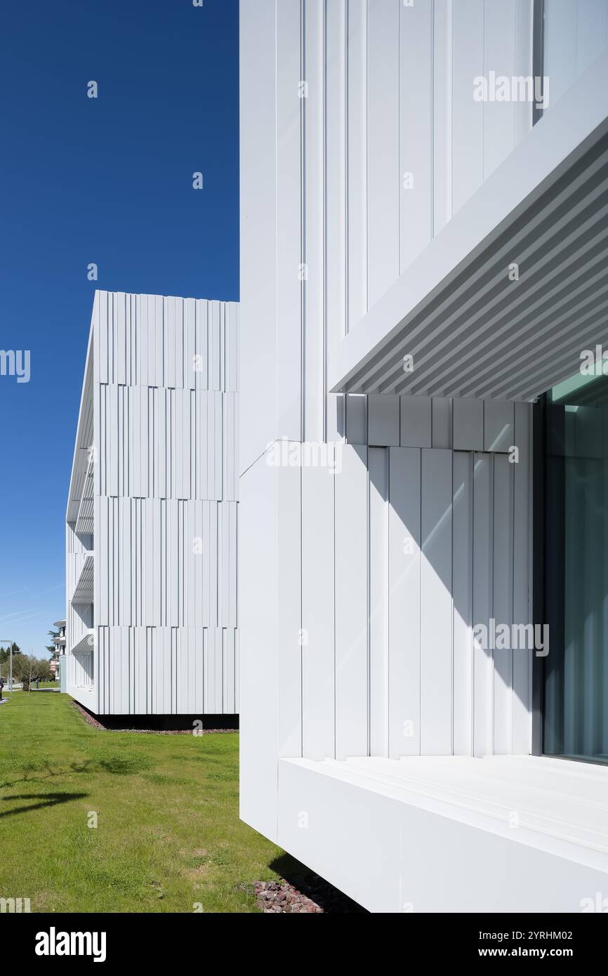 A modern hospital building with sleek white panels and clean lines The ...