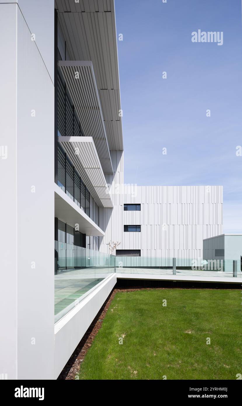 A contemporary hospital building featuring sleek white panels and large ...