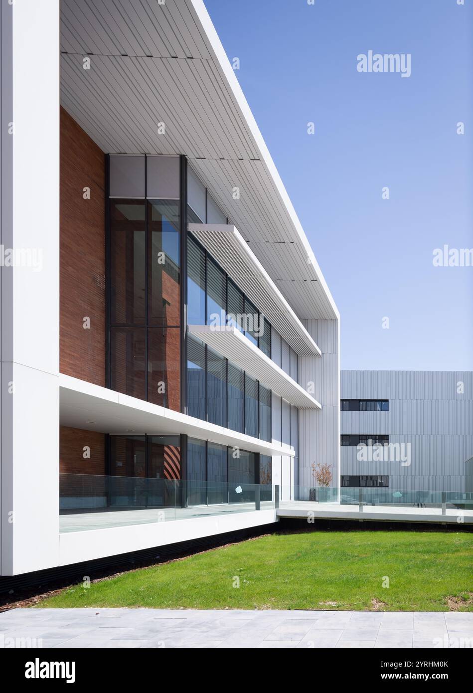 A contemporary hospital facade featuring sleek lines and large glass ...