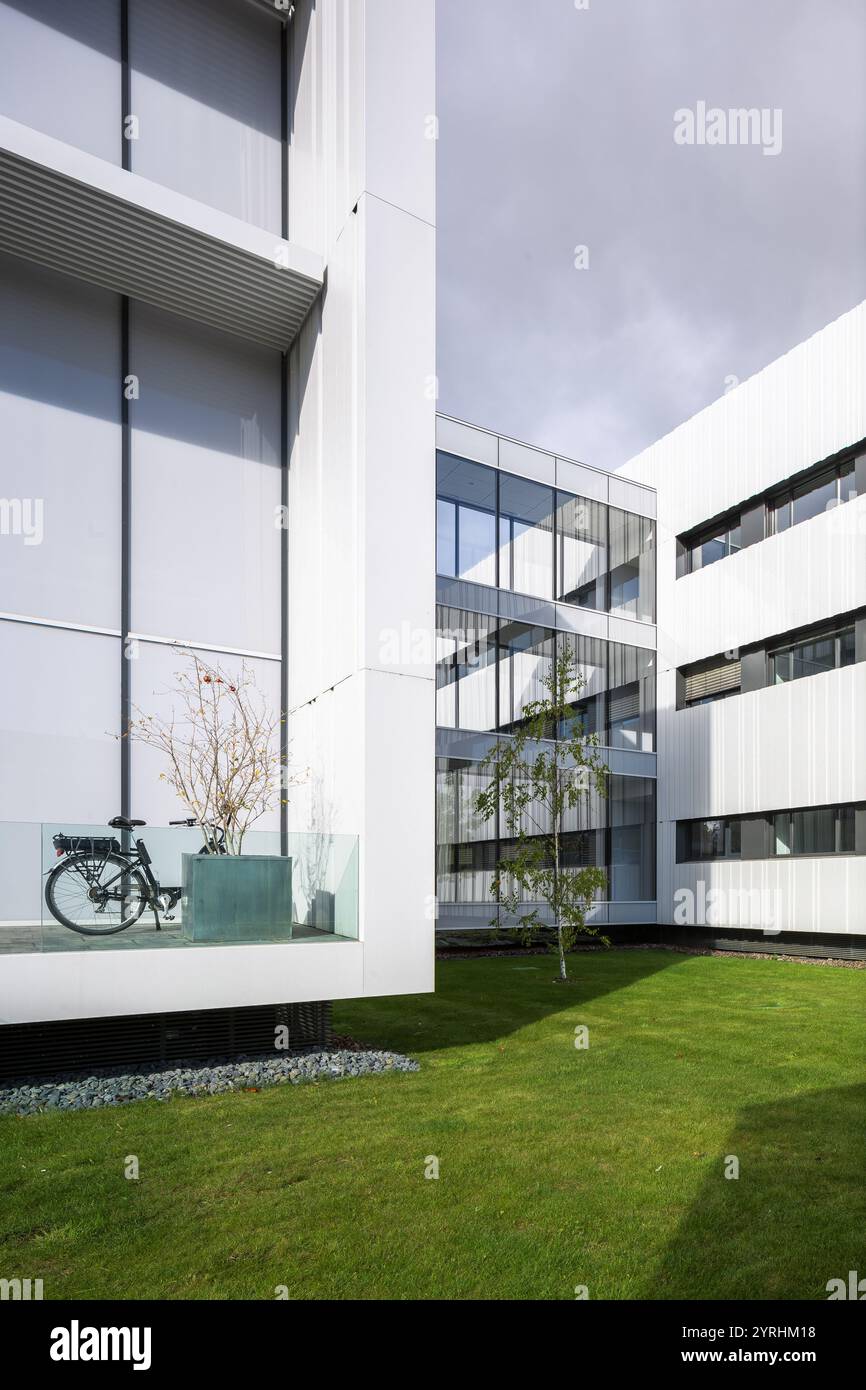 A modern hospital building showcases sleek, white facade and glass ...