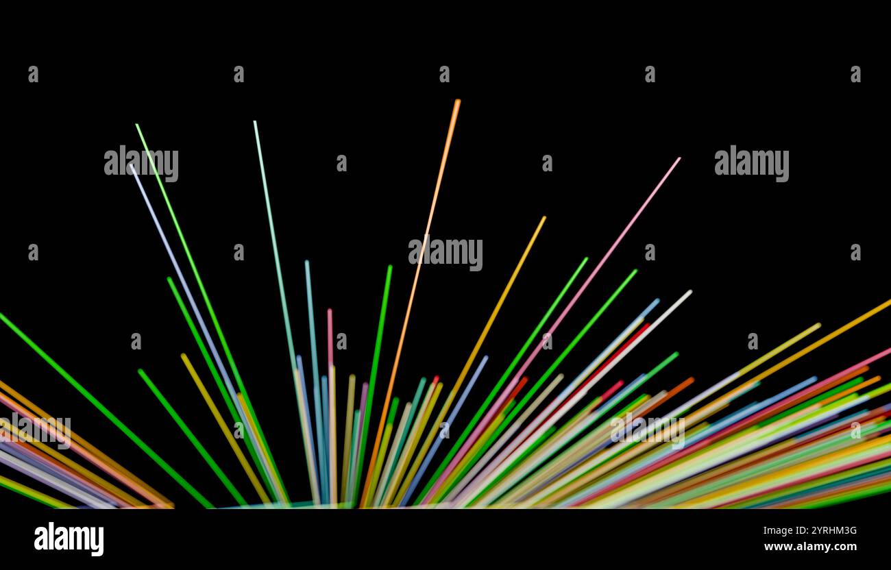 A vivid display of colorful fiber optic strands fanned out against a ...