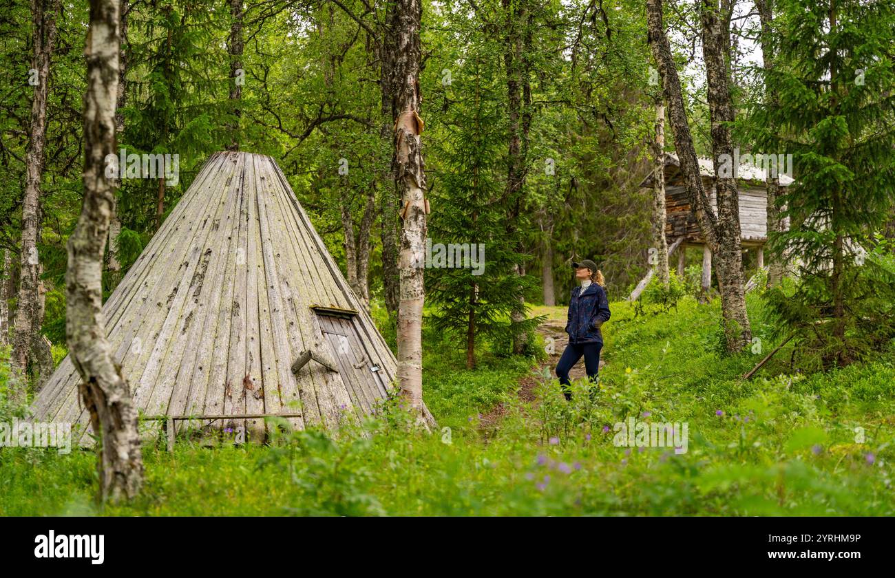 A woman enjoys the peaceful wilderness of Swedish Lapland, surrounded ...
