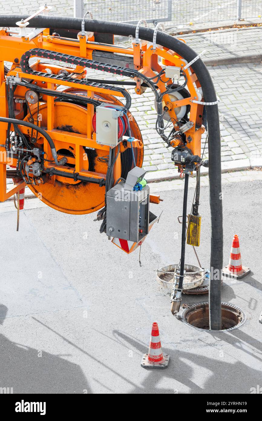 Pipe hose sewage truck car engine emptying city street sewerage manhole ...