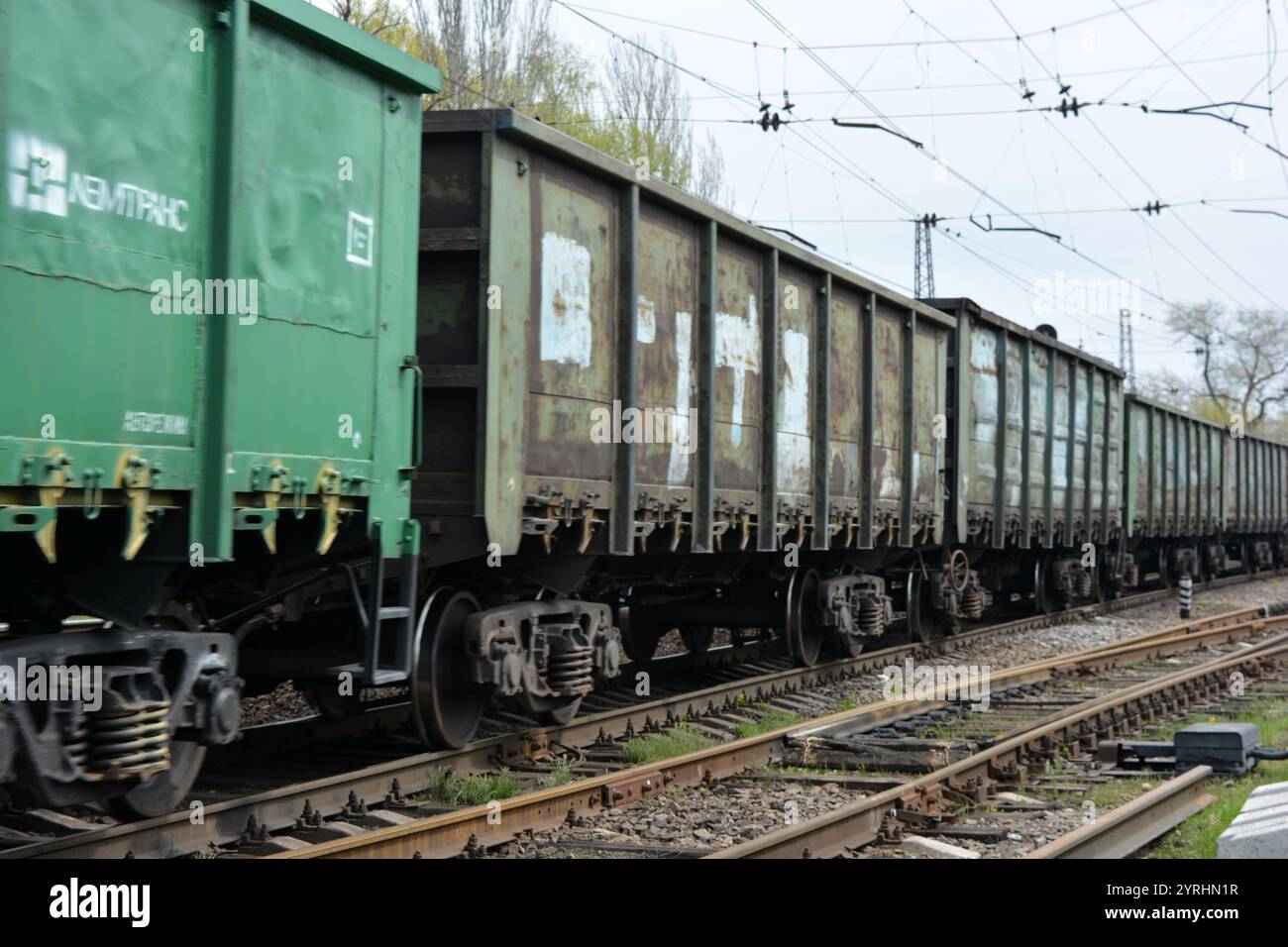 Heavy industry, heavy freight railway loading metal wagons pass along ...