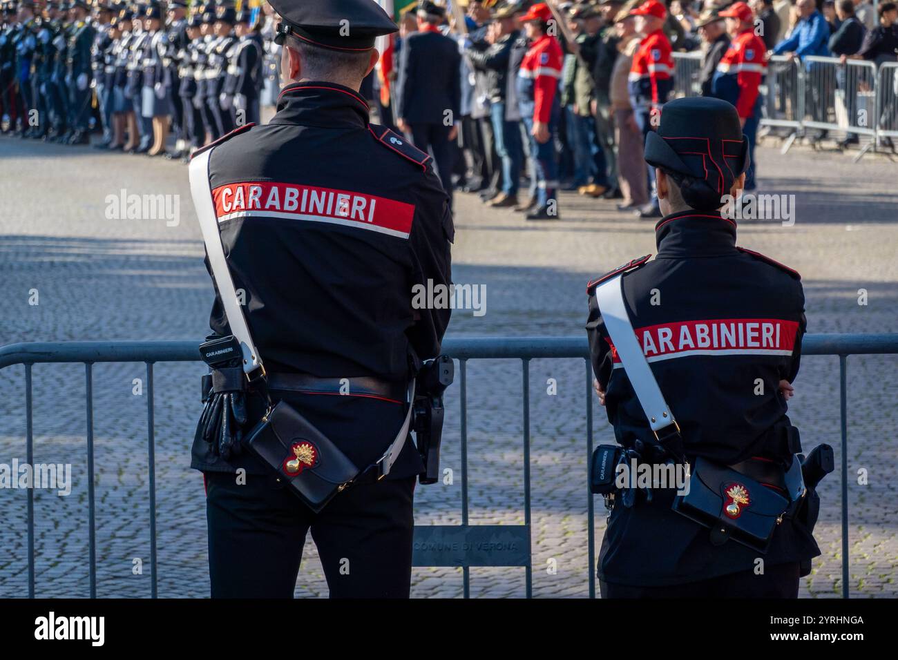 Two Italian carabinieri officers in uniform observe a public event ... Two Italian carabinieri officers in uniform observe a public event ...