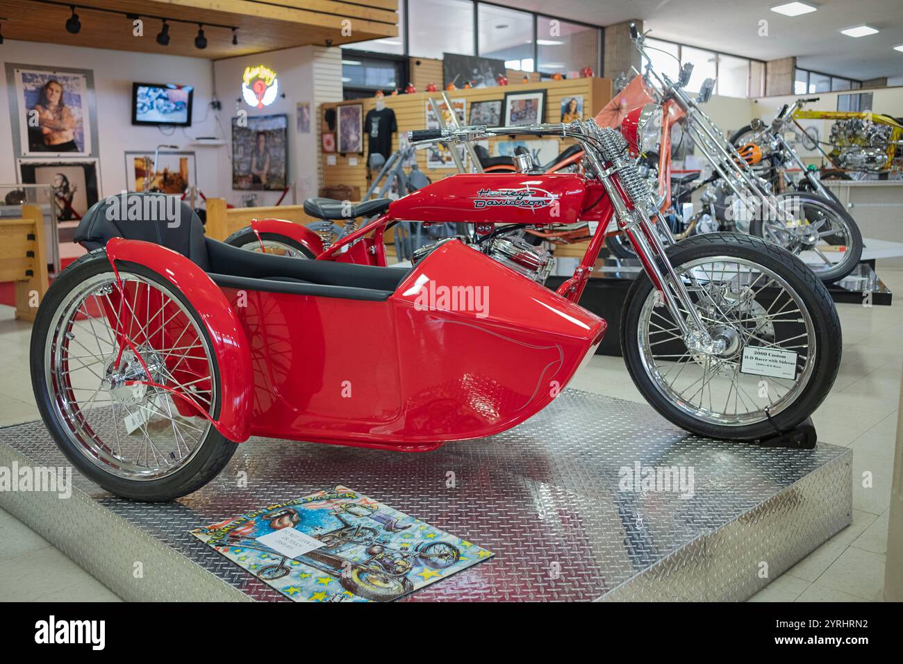A 2009 bright red Custom Harley Davidson Racer with a sidecar displayed ...