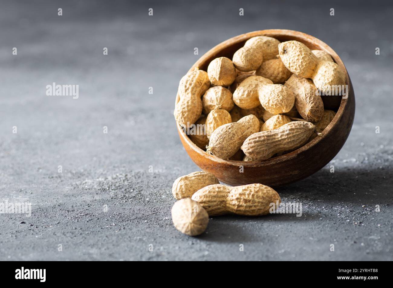 Peanut with nutshell not peeled nut on rustic background, composition ...