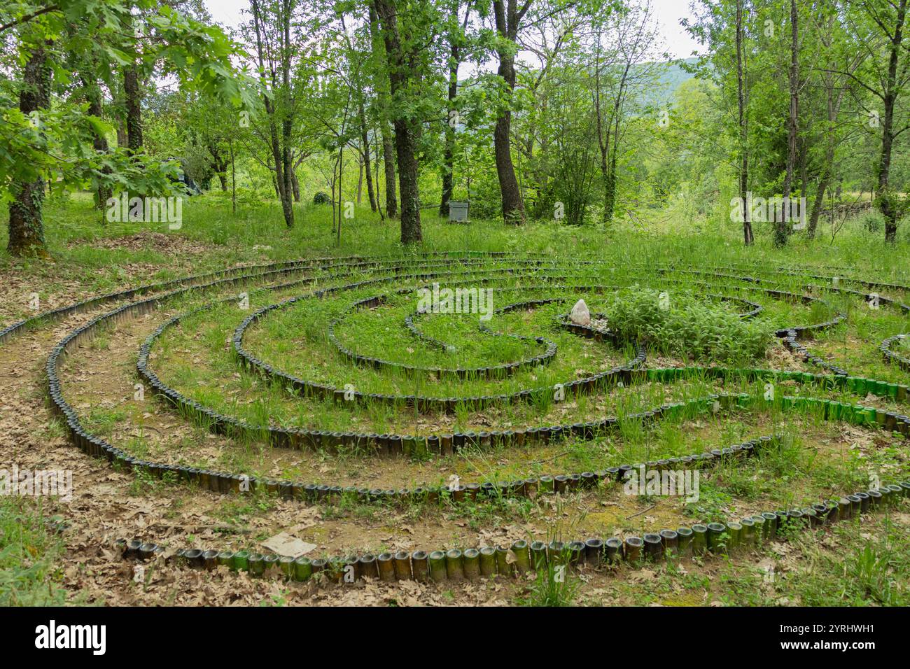 labyrinth made with glass bottles stuck in the ground with a quartz ...