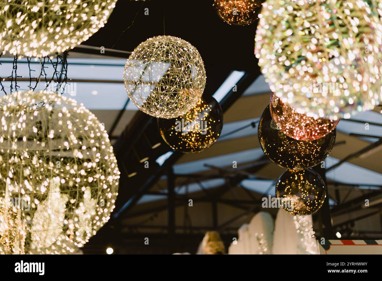 A cluster of lights in the shape of balls. The balls are lit up and are ...