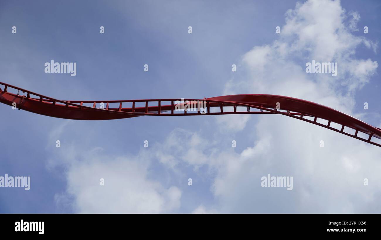 Red coloured, twisted roller coaster track without steel supports in ...