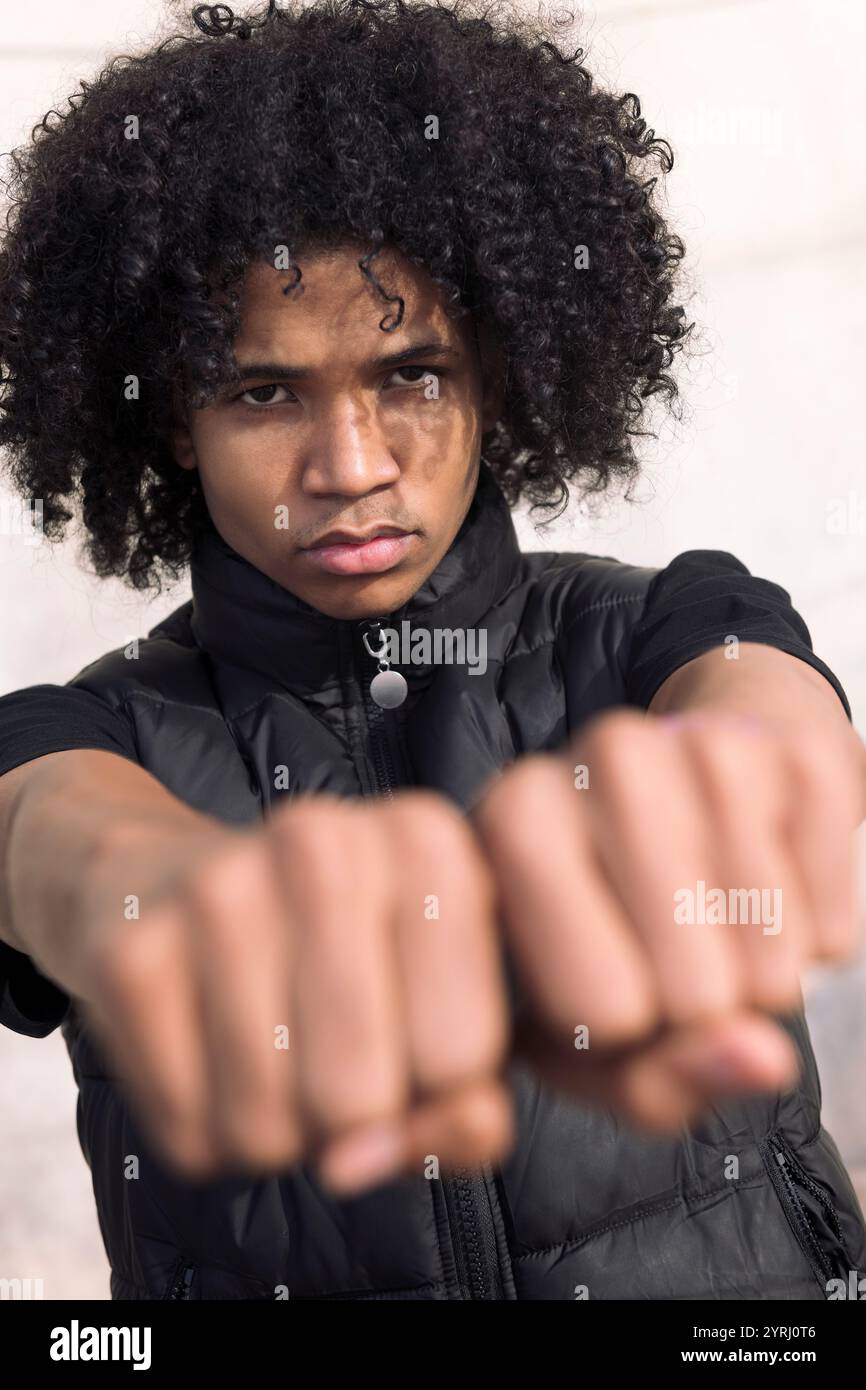 teen male with curly hair spreading fists Stock Photo - Alamy