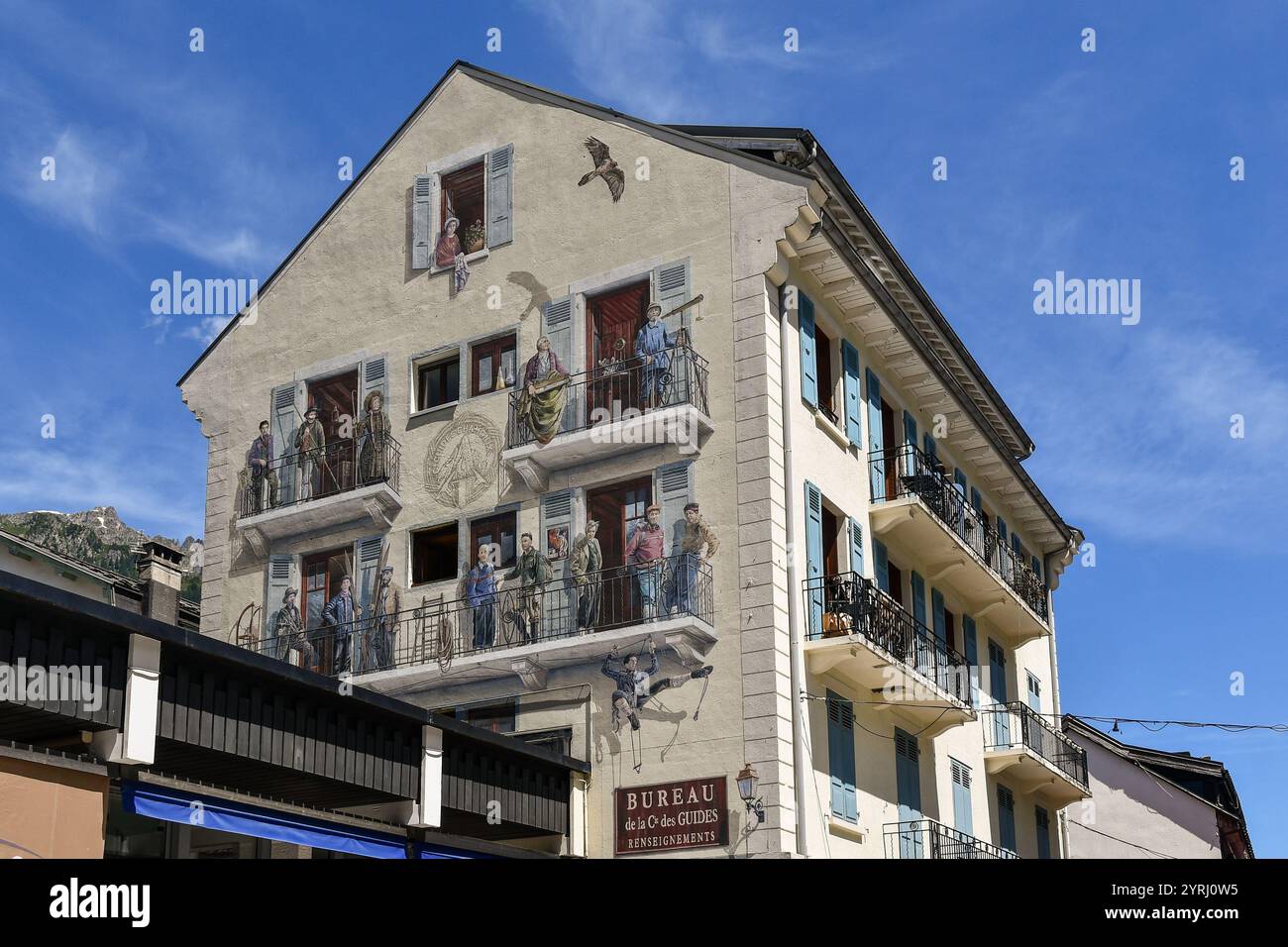 High section of a buildind with a giant mural depicting some of the ...